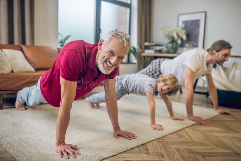 Two Men and Their Son Standing in Plank and Smiling Stock Image - Image ...