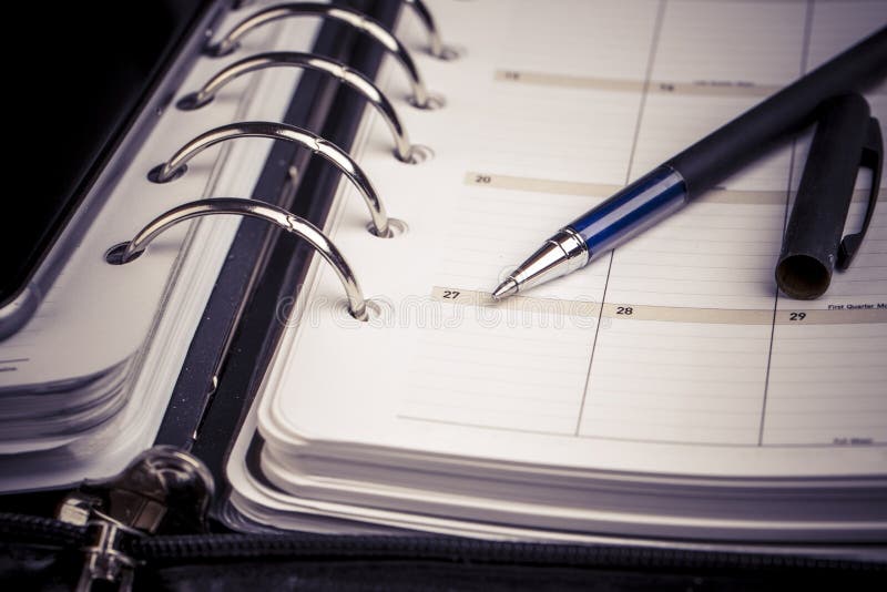 Planner, calendar and pen stock photo. Image of book - 70098294