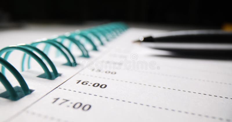 Daily Planner with Time Schedule by Clock and Ballpoint Pen Closeup ...