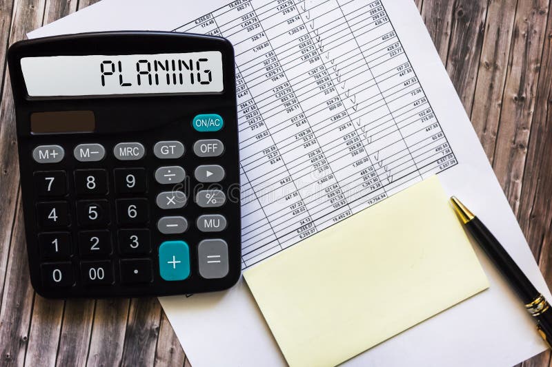 PLANNING on a Calculator and on a Table with Papers and a Notepad ...
