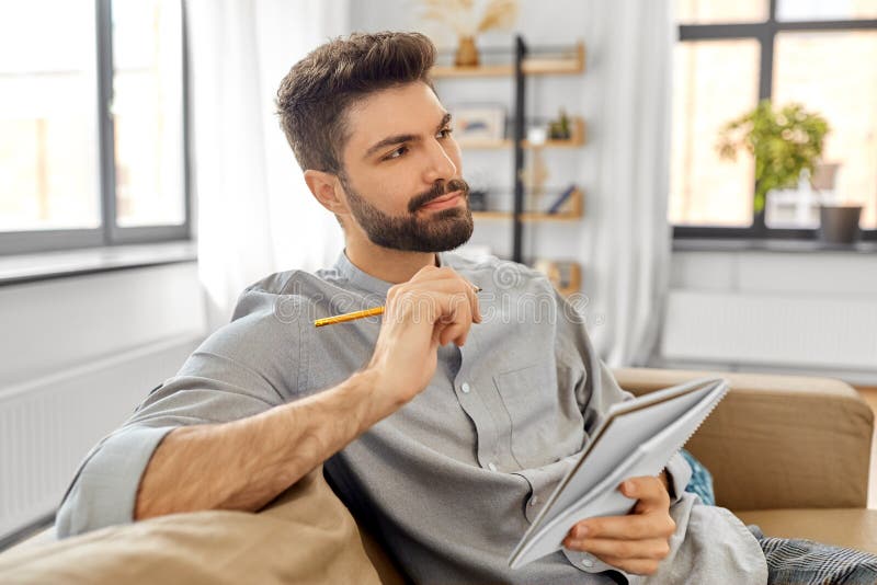 Man Writing To Notebook and Thinking at Home Stock Image - Image of ...