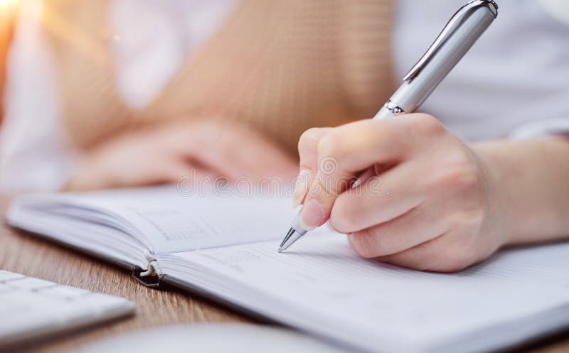 Planning Working Schedule Writing in Notebook while Sitting at Working ...