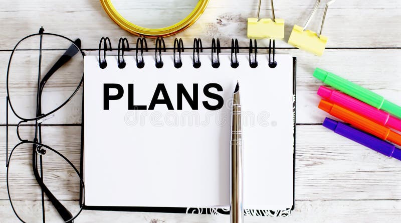 PLANS Written in a Notebook on White Background with Office Tools Stock ...