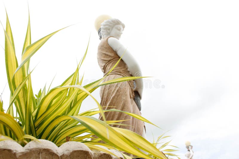 Plant with a statue stock photo. Image of lights, landmarks - 199174006