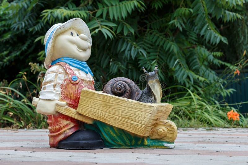 Plaster Figure of the Gardener with a Snail Stock Photo - Image of ...