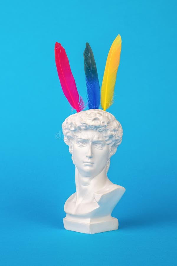 Plaster Statuette with Three Feathers in the Head on a Blue Background ...