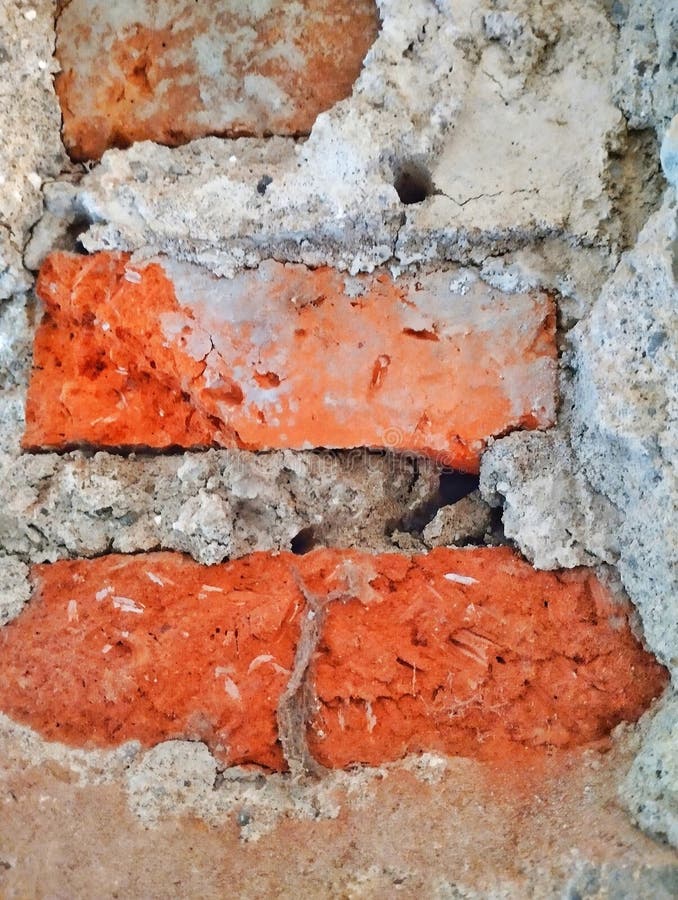 The Plaster on the Wall is Peeling Off and the Red Bricks are Visible ...