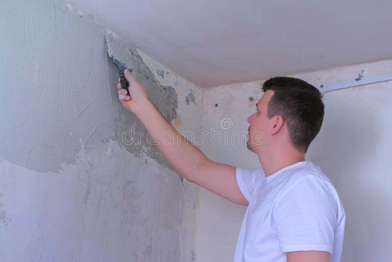 Plasterer Man Spackling Wall with Putty Plaster Aligning Wall Using ...