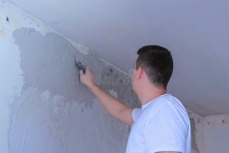 Plasterer Man Spackling Wall with Putty Plaster Aligning Wall Using ...