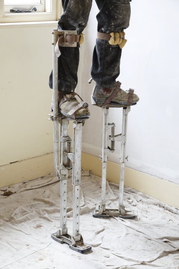 Plasterer Plastering on Stilts Stock Image - Image of plasterer ...