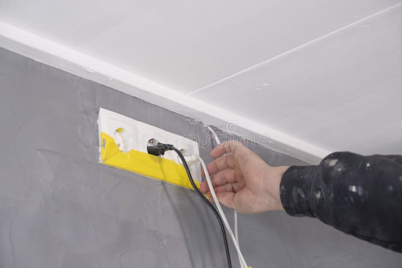 Plasterer Removes the Yellow Protective Tape from the Socket Stock ...