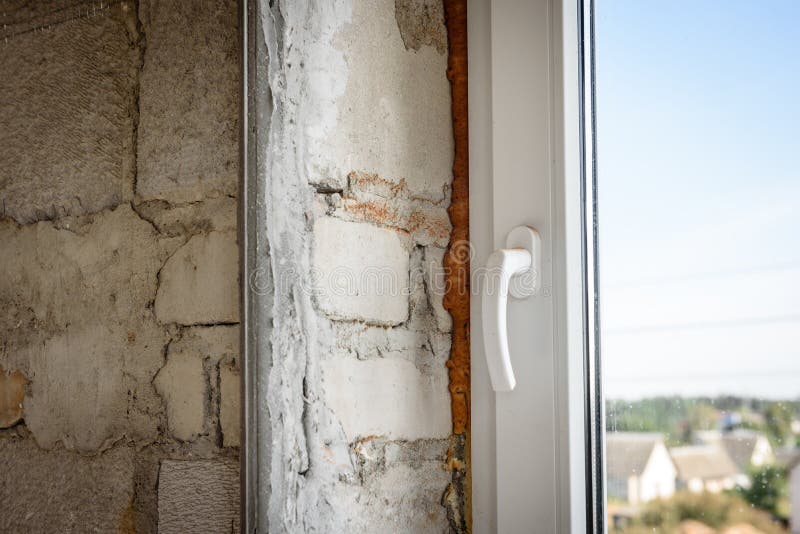 The Plasterer Repairs the Corners of the Window with a Spatula and ...