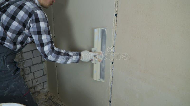 Plasterer Smoothing Plaster on Interior Wall with Construction Ruler ...