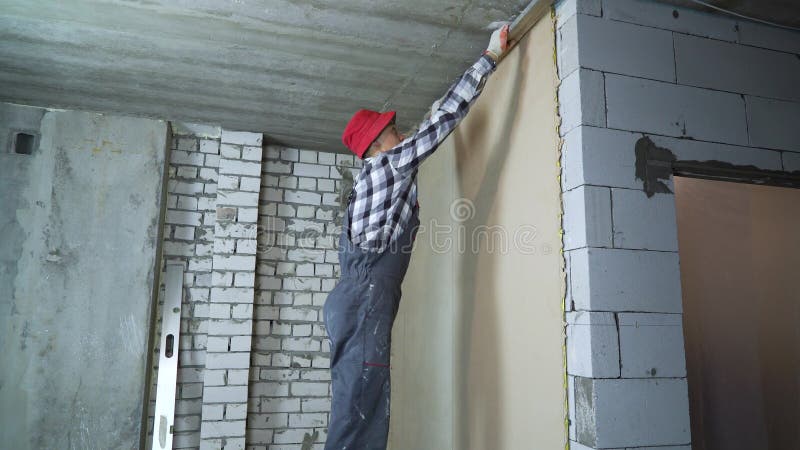 Plasterer Smoothing Plaster on Interior Wall with Construction Ruler ...