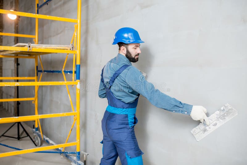 Plasterer working indoors stock image. Image of manual - 112961951