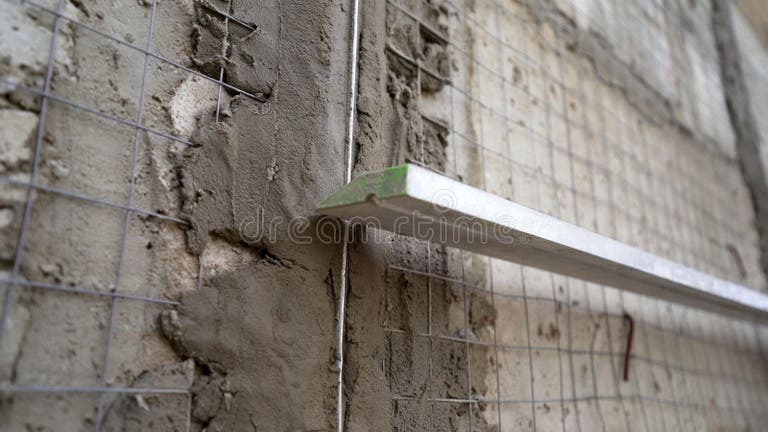Plastering a Wall Using Metal Lath and a Leveling Tool Stock Photo ...
