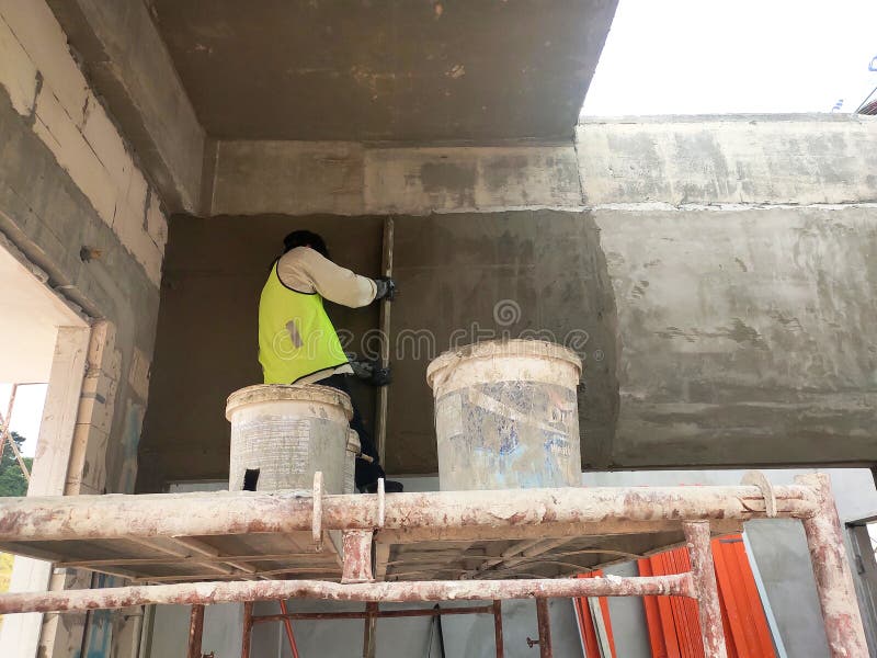 Plastering Work by Construction Workers Using the Cement Plaster ...