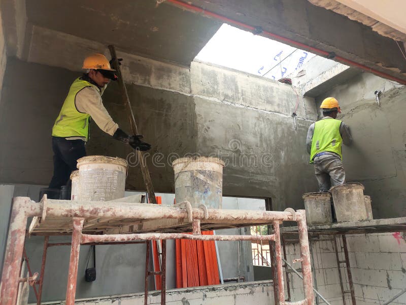 Plastering Work by Construction Workers Using the Cement Plaster ...