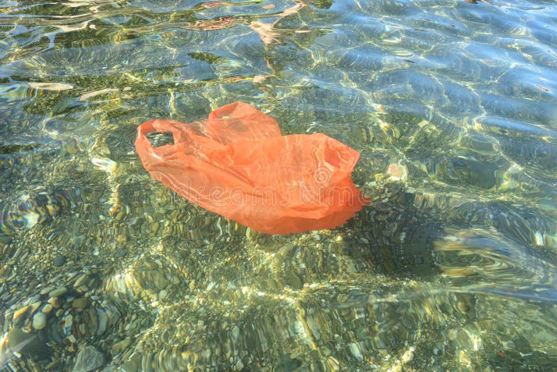 A bag floating in the sea stock photo. Image of damage - 155564306
