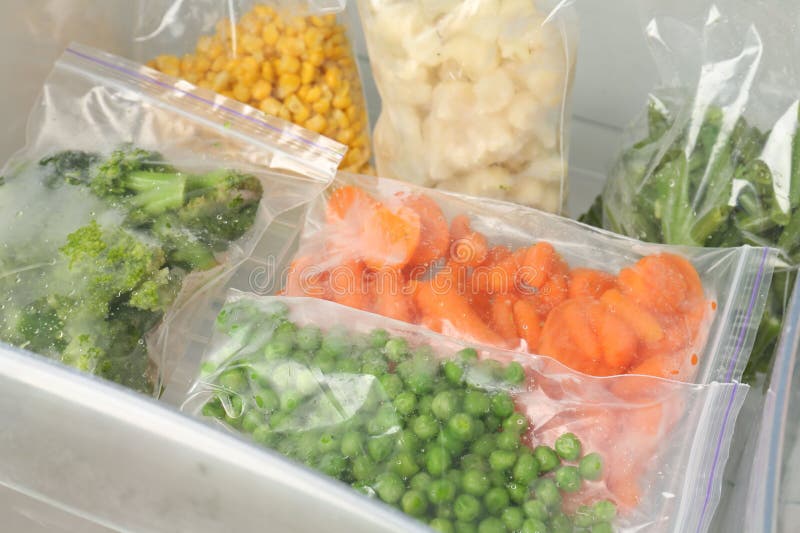 Plastic Bags with Different Frozen Vegetables in Refrigerator, Closeup ...