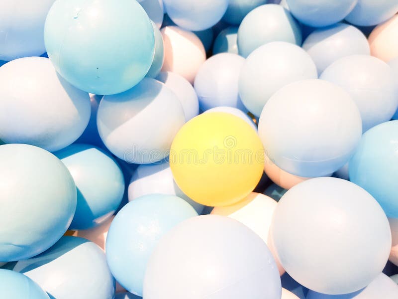 Yellow Plastic Ball among Blue Plastic Ball Stock Photo - Image of ...