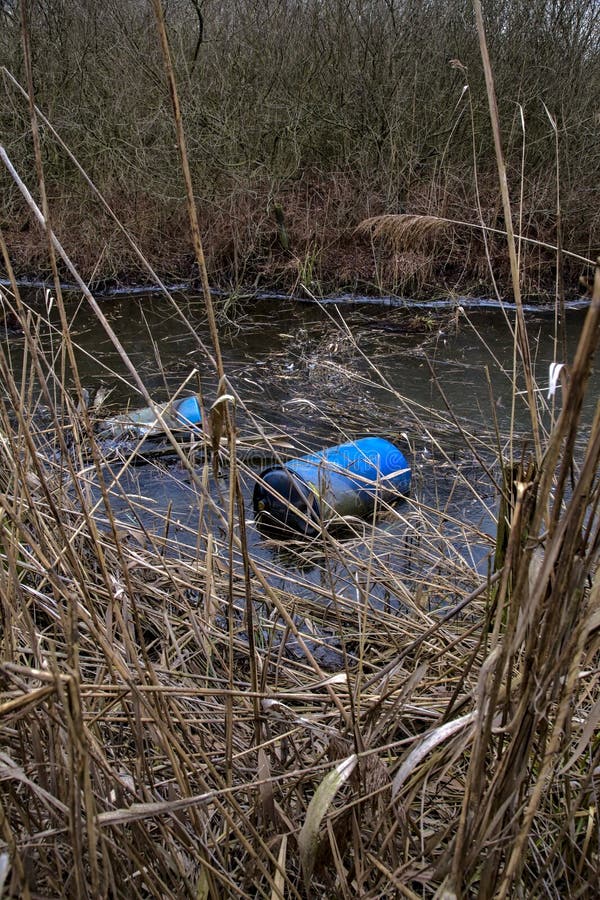 Plastic Barrels Floating in a Stream of Water in a Marsh Stock Photo ...