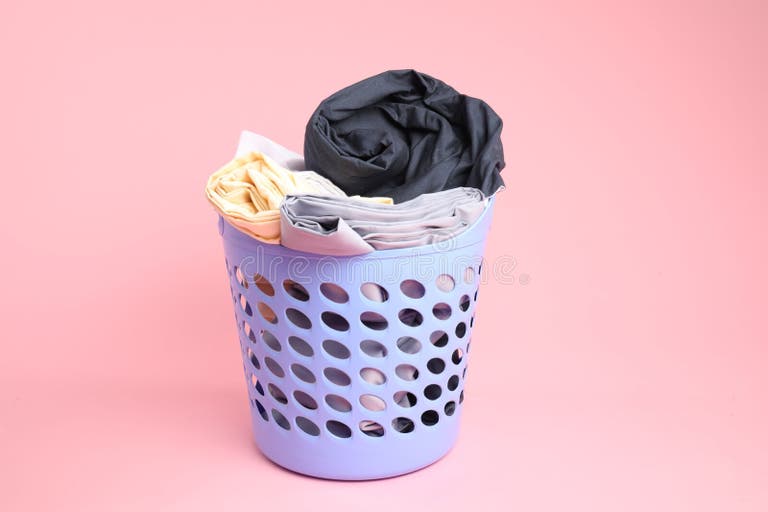 Plastic Basket Full of Laundry on Pink Background Stock Photo - Image ...