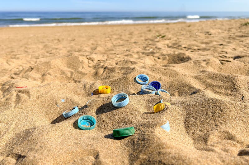 Plastic Bottle Caps Discarded on the Beach, Ecological Problem Stock ...