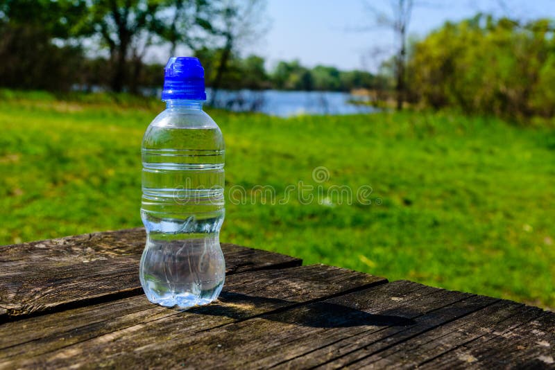Plastic Bottle with the Clear Water on Wooden Table Stock Image - Image ...
