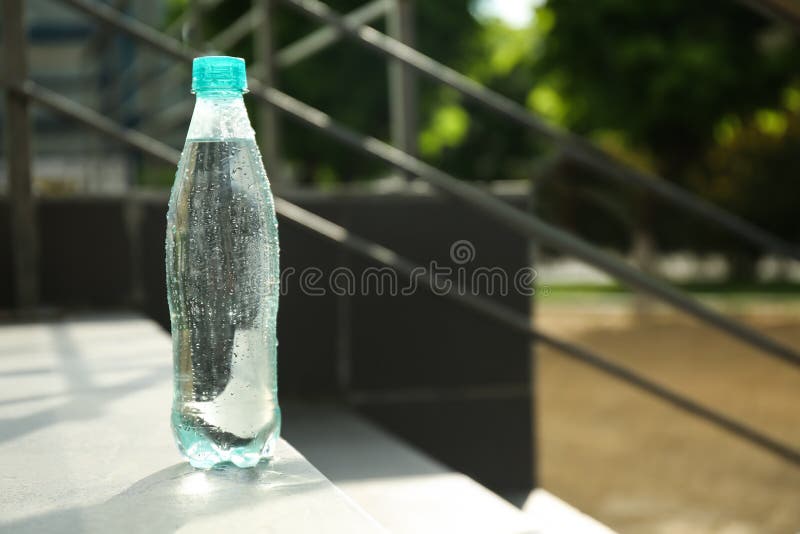 Plastic Bottle of Cold Pure Water Outdoors. Space for Text Stock Photo ...