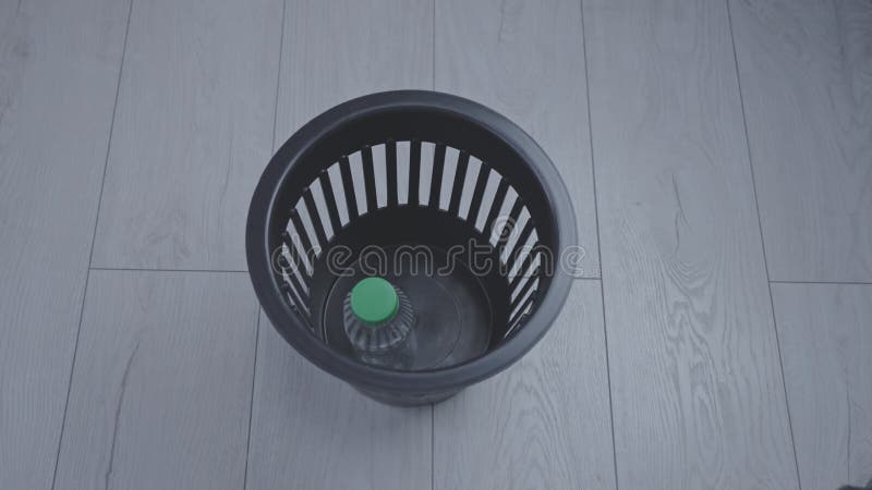 Plastic Bottle Falling into Small Black Garbage Bin Stock Video - Video ...