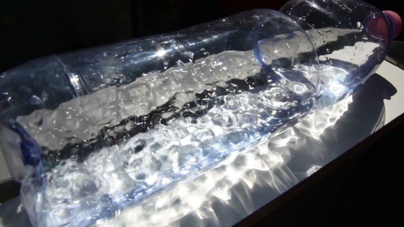 Plastic Bottle Half-full of Water Lies on Its Side Stock Video - Video ...