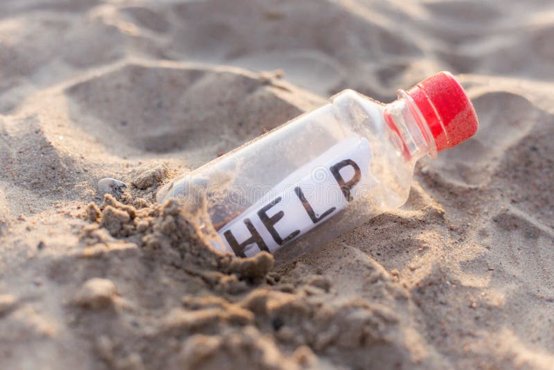 A Plastic Bottle with the Message Help Inside Lies on the Sand of a ...