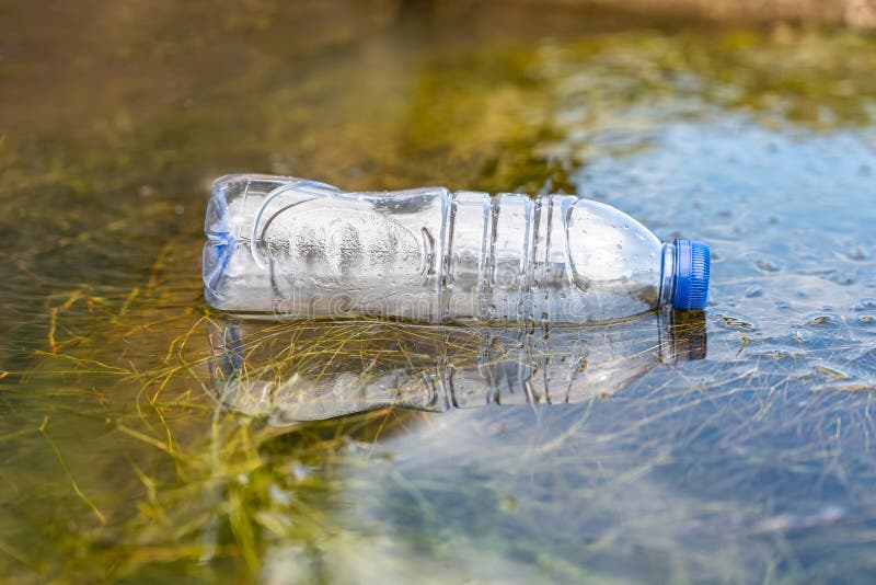 Plastic Bottle Thrown into a River and Polluting the Environment by ...