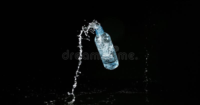 Plastic Bottle of Water Falling and Splashing Against Black Background ...