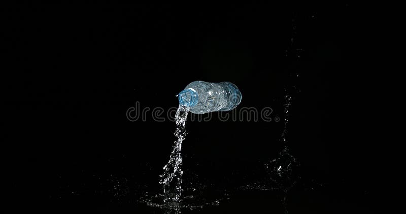 Plastic Bottle of Water Falling and Splashing Against Black Background ...