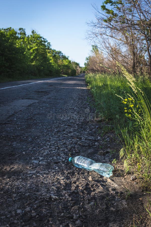 Plastic Bottle with Water by the Road Stock Photo - Image of litter ...