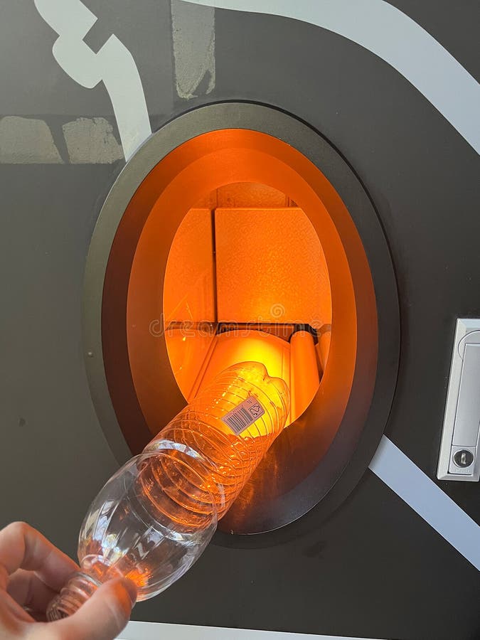 Plastic Bottles Recycling Machine. Hand Puts in Plastic Bottle. Stock ...