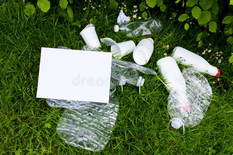 Plastic Bottles and Trash on Grass Highlighting Environmental Pollution ...