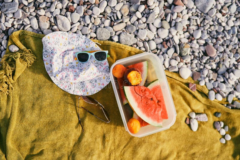 Plastic Box with Watermelon and Peaches on a Blanket on the Beach Stock ...