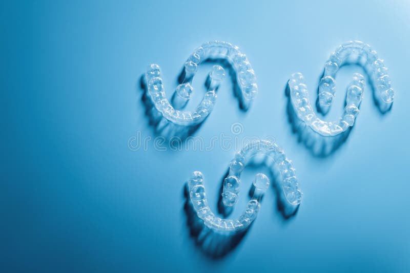 Plastic Braces in the Shape of a Pattern Lie on a Blue Background ...