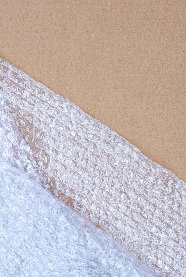 Plastic Bubble Wrap on Brown Cardboard Paper Sheet Background in ...
