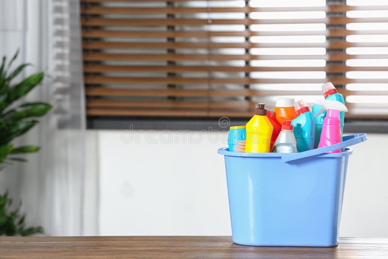 Plastic Bucket with Different Cleaning Products on Table Indoors Stock ...