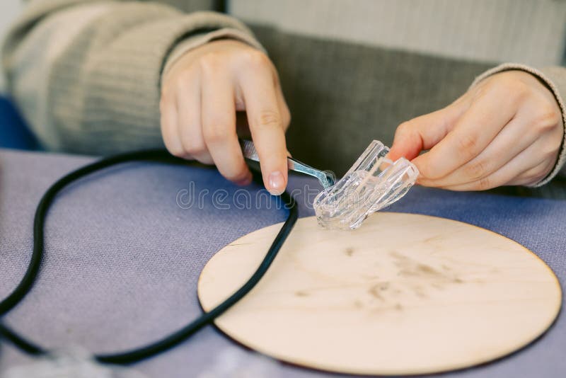 Plastic Burning Tool. Person Connects Plastic Plates into Figure Using ...