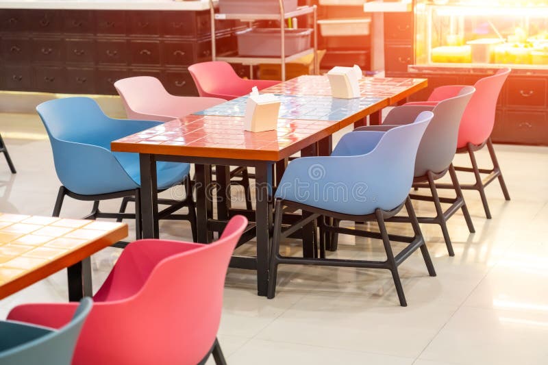 Plastic Chairs and Wooden Tables with Colored Bright Ceramic Tiles in ...