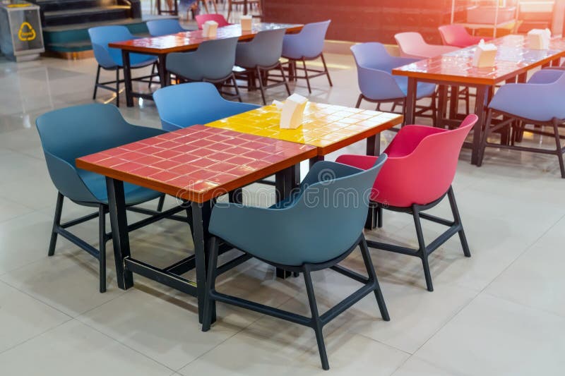 Plastic Chairs and Wooden Tables with Colored Bright Ceramic Tiles in ...