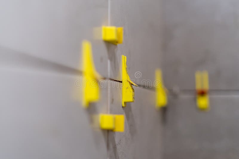 Plastic Clips and Wedges Securing Tiles in Place for Perfect Alignment ...