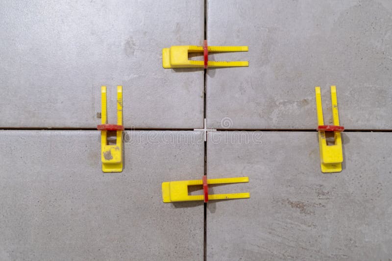 Plastic Clips and Wedges Securing Tiles in Place for Perfect Alignment ...