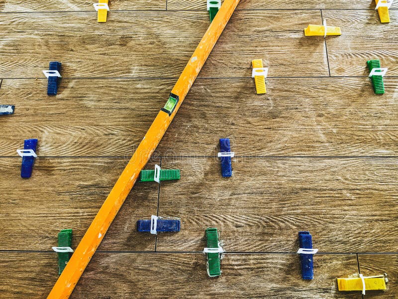 Plastic Clips and Wedges Securing Tiles in Place for Perfect Alignment ...