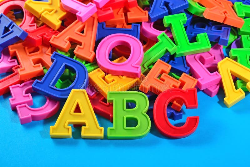 Plastic Colored Alphabet Letters ABC on a Blue Stock Image - Image of ...